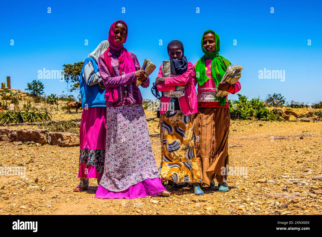 Colourfully dressed schoolgirls at their way home at the Pre-Aksumite ...