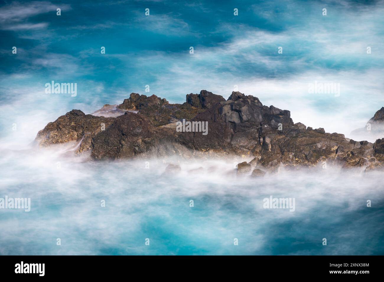 Aerial view of small rock island amongst waves, Madeira, Portugal ...