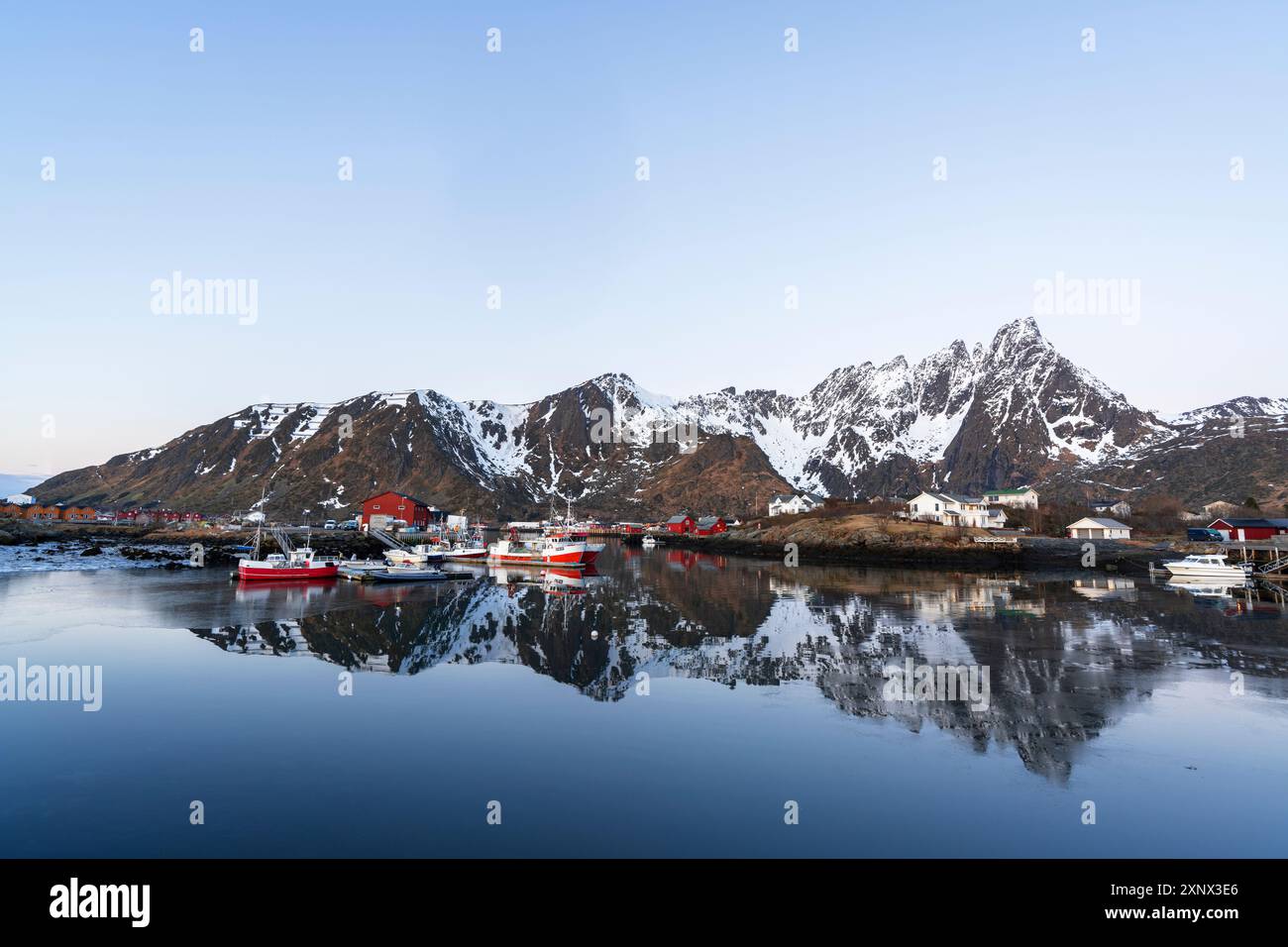 Calm water reflecting the Arctic landscape of the traditional fishing ...
