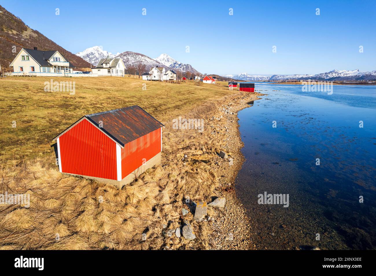 Traditional red cabins by the fjord seen in a sunny clear day, Leknes ...