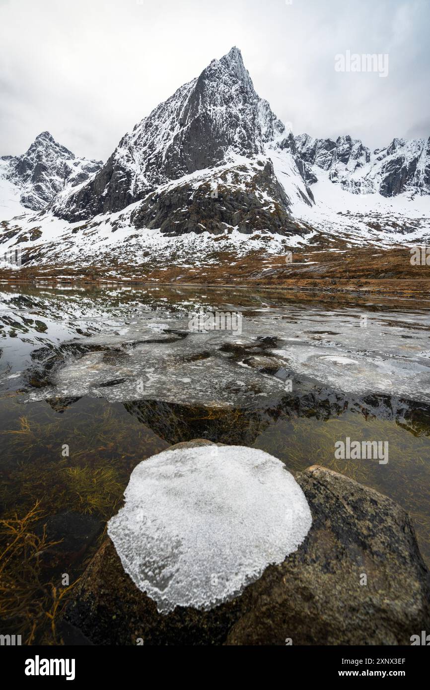 Ice formation on top of a rock in the Arctic landscape, Flakstadoya ...