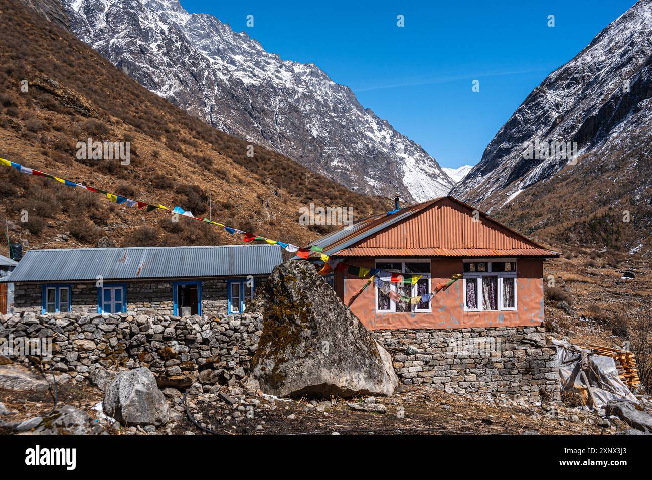 Colorful Tin Huts with snow-covered mountain peaks in the background on ...