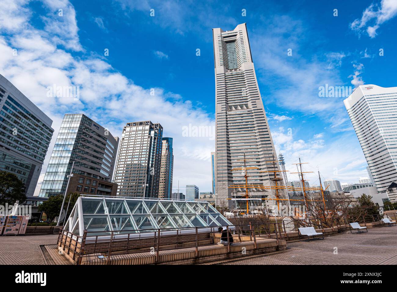 Yokohama Landmark Tower and surrounding skyscrapers against a blue sky ...
