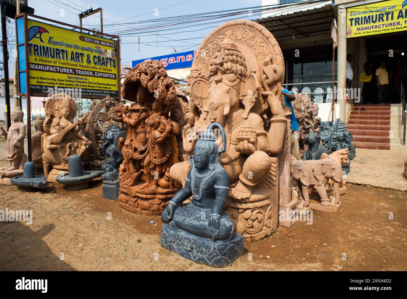 Statues of Hindu deities on view in front of a roadside trader's shop ...