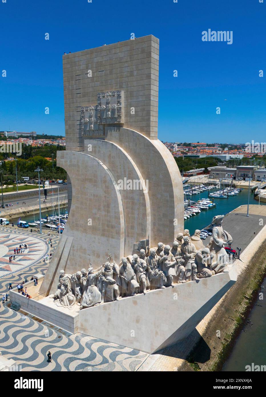 Riverside monument with several statues under a clear sky in an urban ...