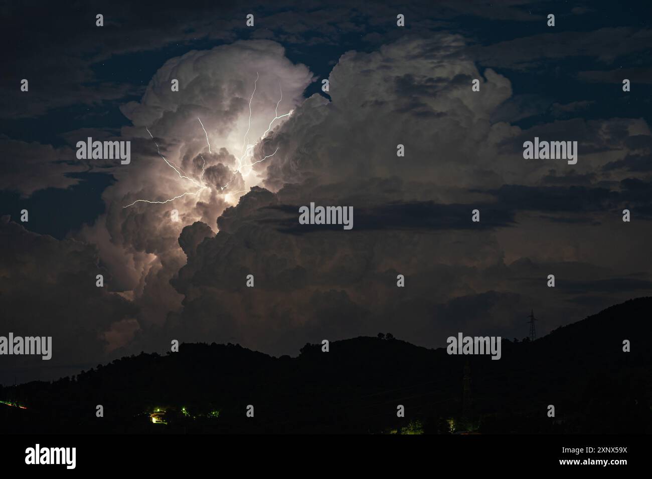 Star shaped lightning in a tall storm cloud over the hills of Tuscany ...