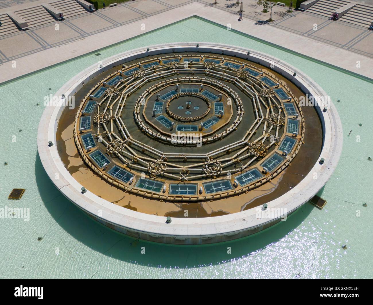Circular fountain with complex geometric design, embedded in an ...