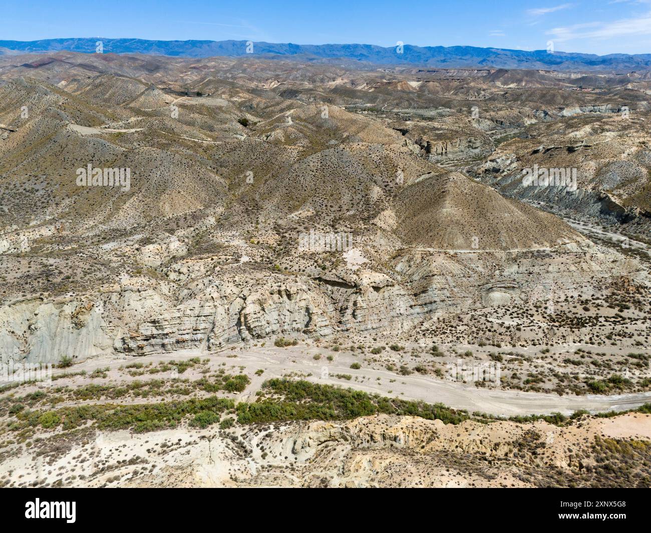 Wide valley in dry mountain landscape with sparse vegetation, aerial ...