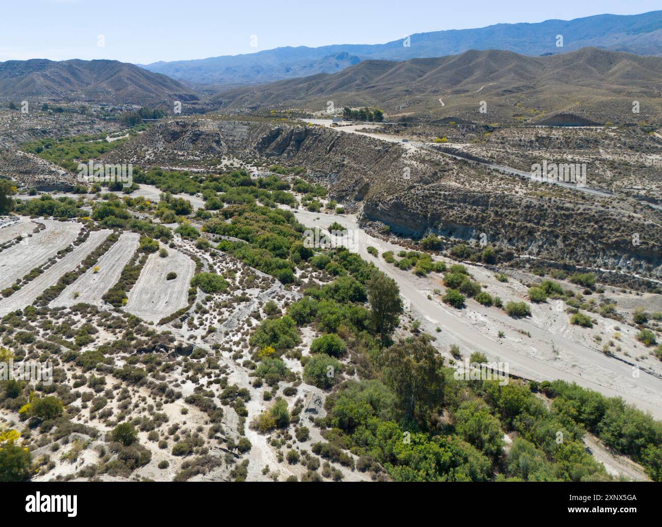 Dry mountainous landscape with river beds and sparse vegetation, aerial ...