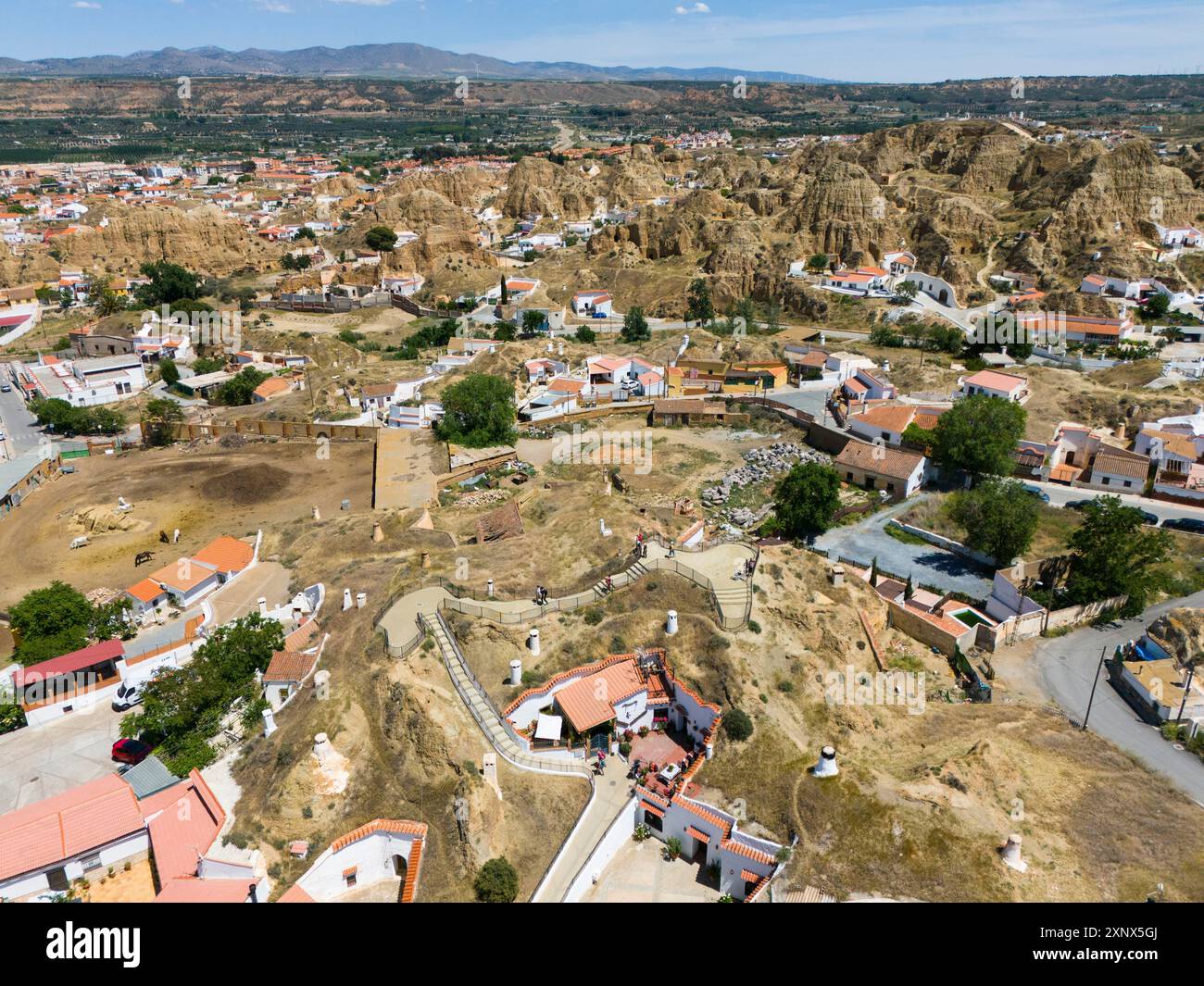 Aerial view of a village surrounded by hilly and stony landscape with ...