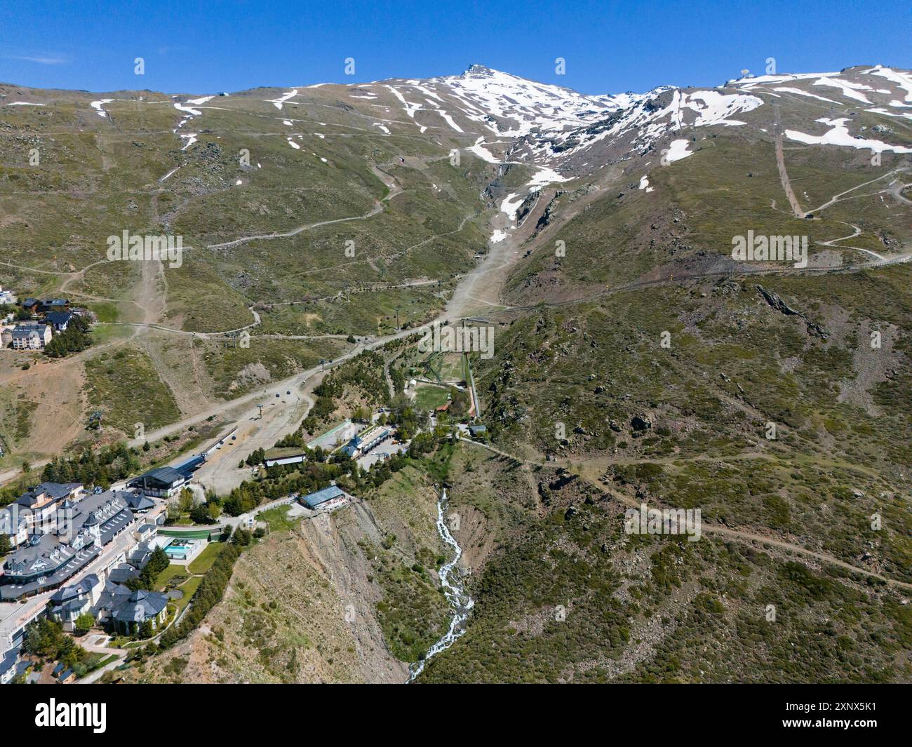 Aerial view of a mountain area with snow-covered peaks and hiking ...