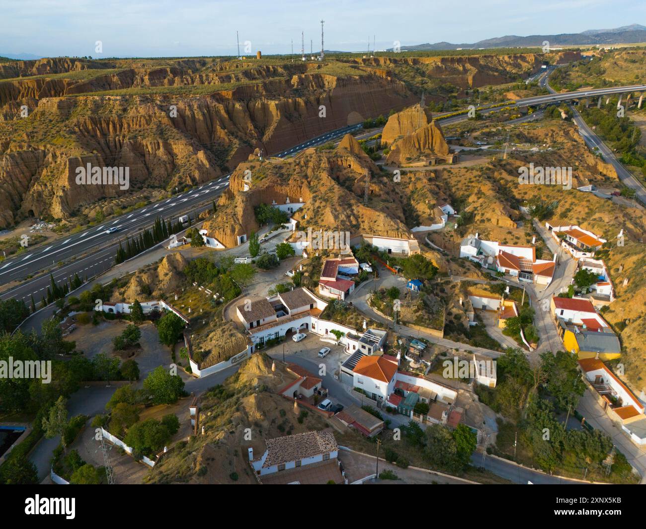 Aerial view of a housing estate in a rocky, hilly environment with cave ...