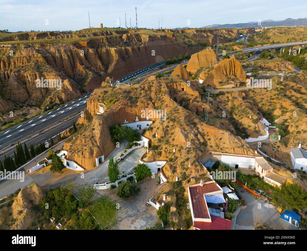 Aerial view of a rocky landscape with cave houses, roads and vegetation ...