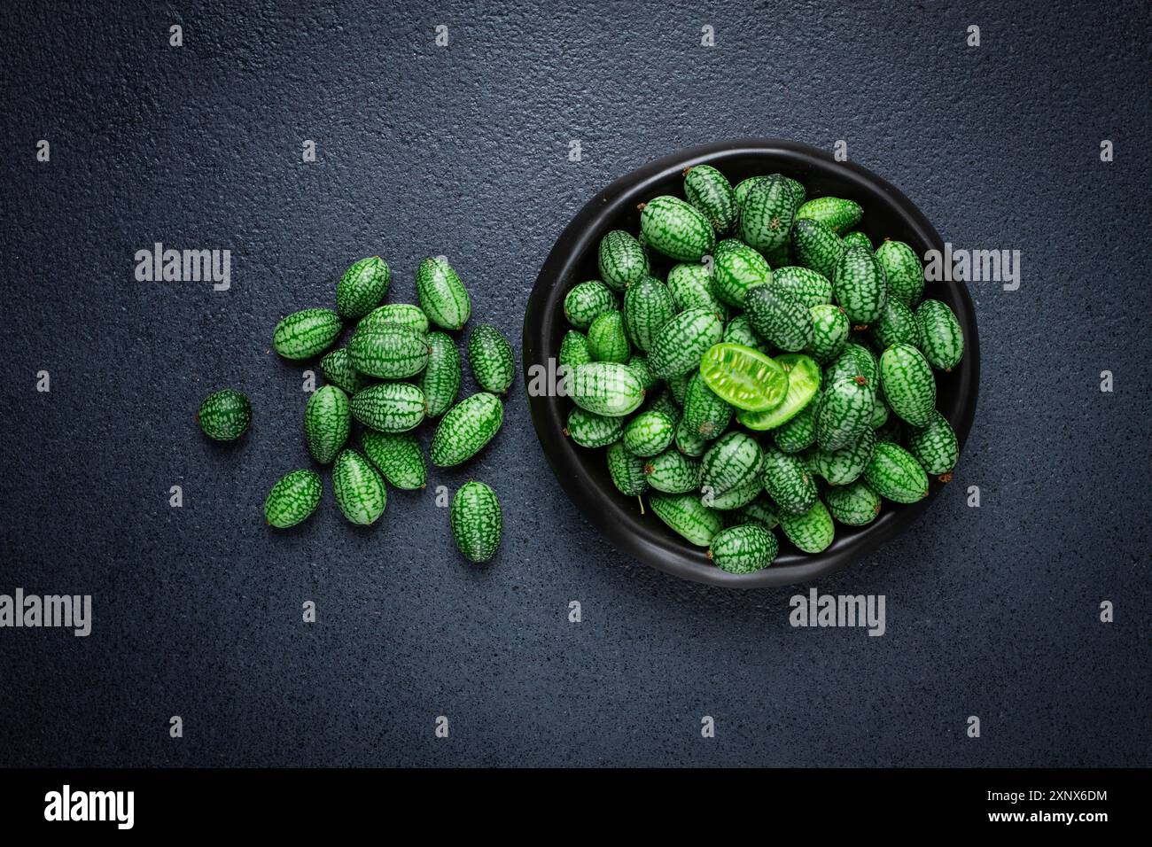African cucumber, Mexican cucumber, mouse melon, Melothria, on a black ...