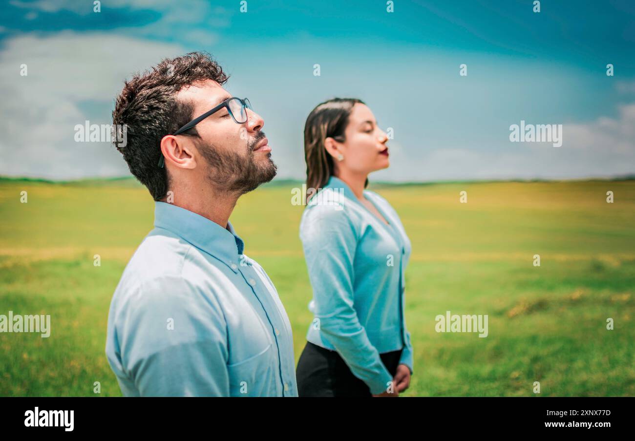 Young couple breathing fresh air in the field. Two relaxed people ...