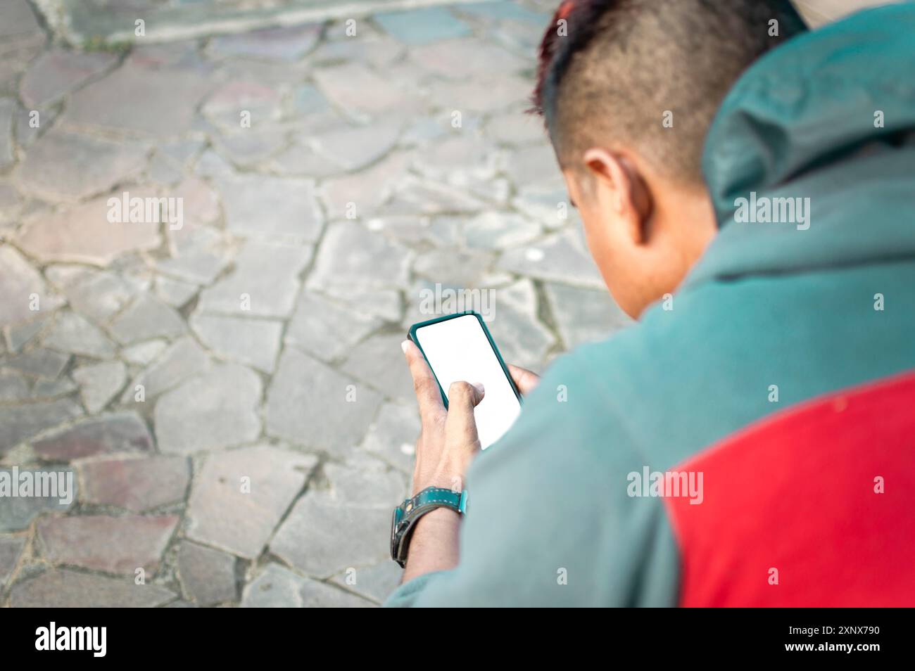 Man sitting with smartphone checking text message Stock Photo - Alamy