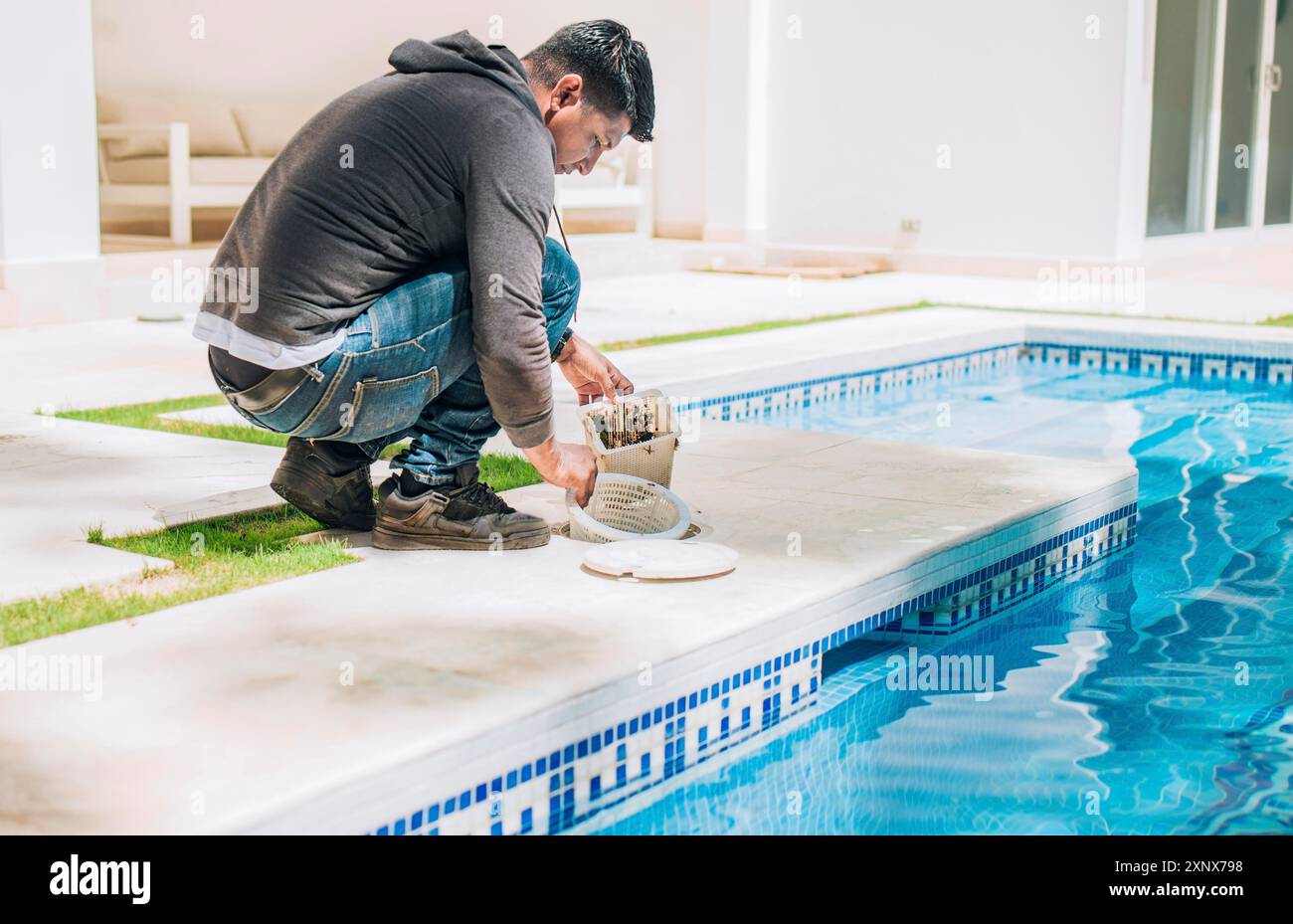 Man cleaning swimming pool filter basket. Person cleaning garbage ...