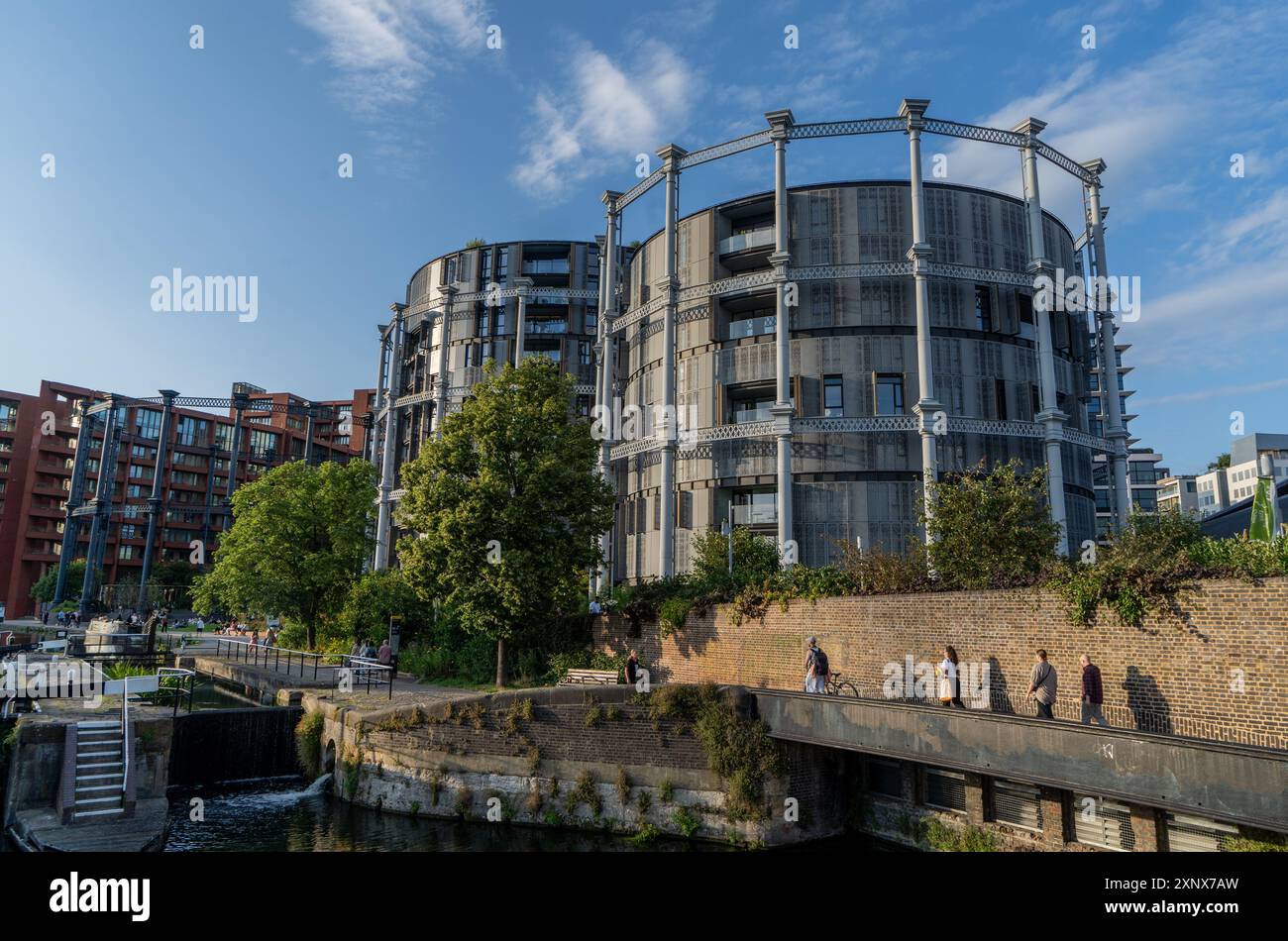 People walking, enjoying restaurants and bars by gasworks near Granary ...