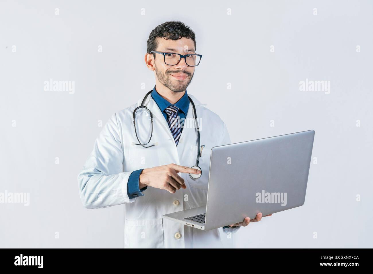 Doctor pointing camera using laptop hi-res stock photography and images ...