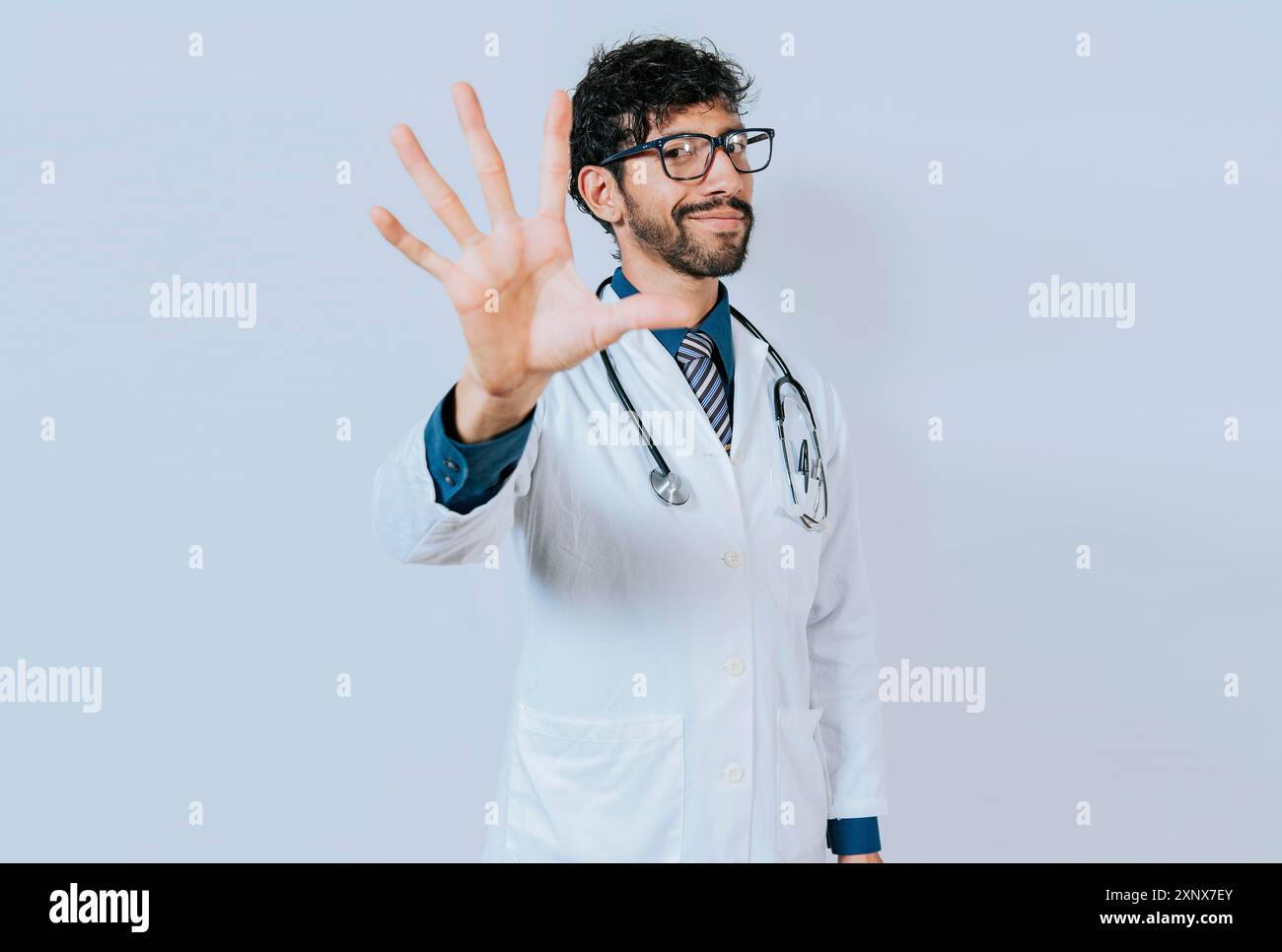 Doctor counting number five isolated. Young doctor counting number 5 on ...