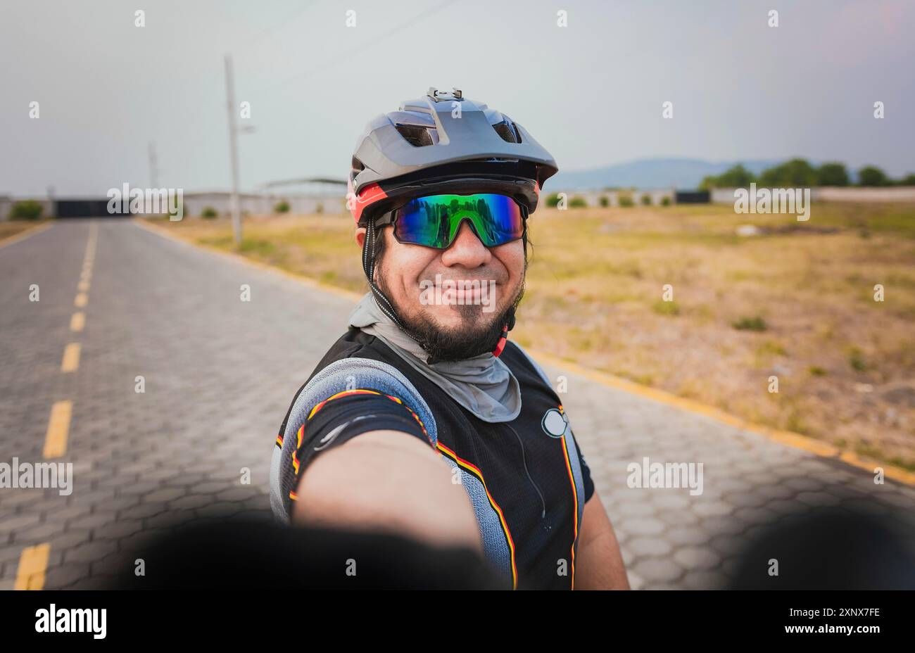 Happy Cyclist with glasses and helmet taking a selfie. Self portrait of ...