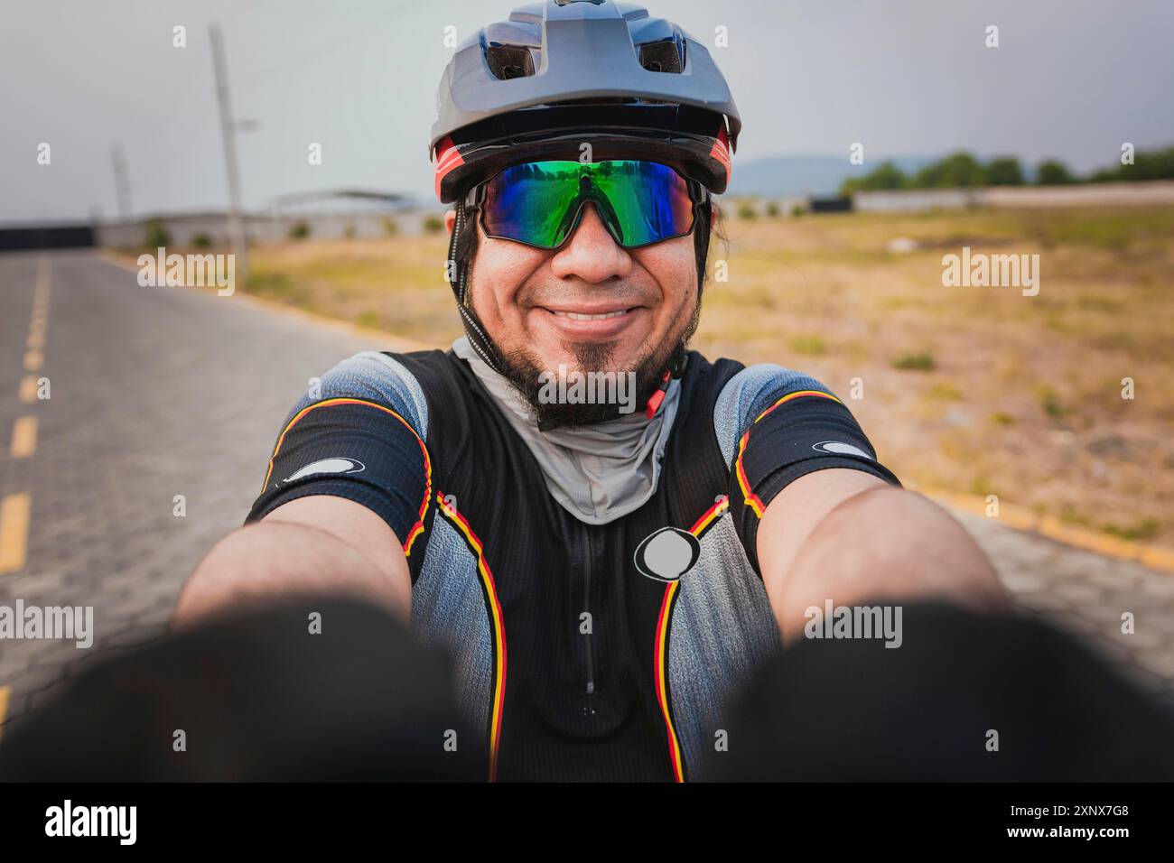 Self portrait of happy male cyclist outdoors. Happy Cyclist with ...