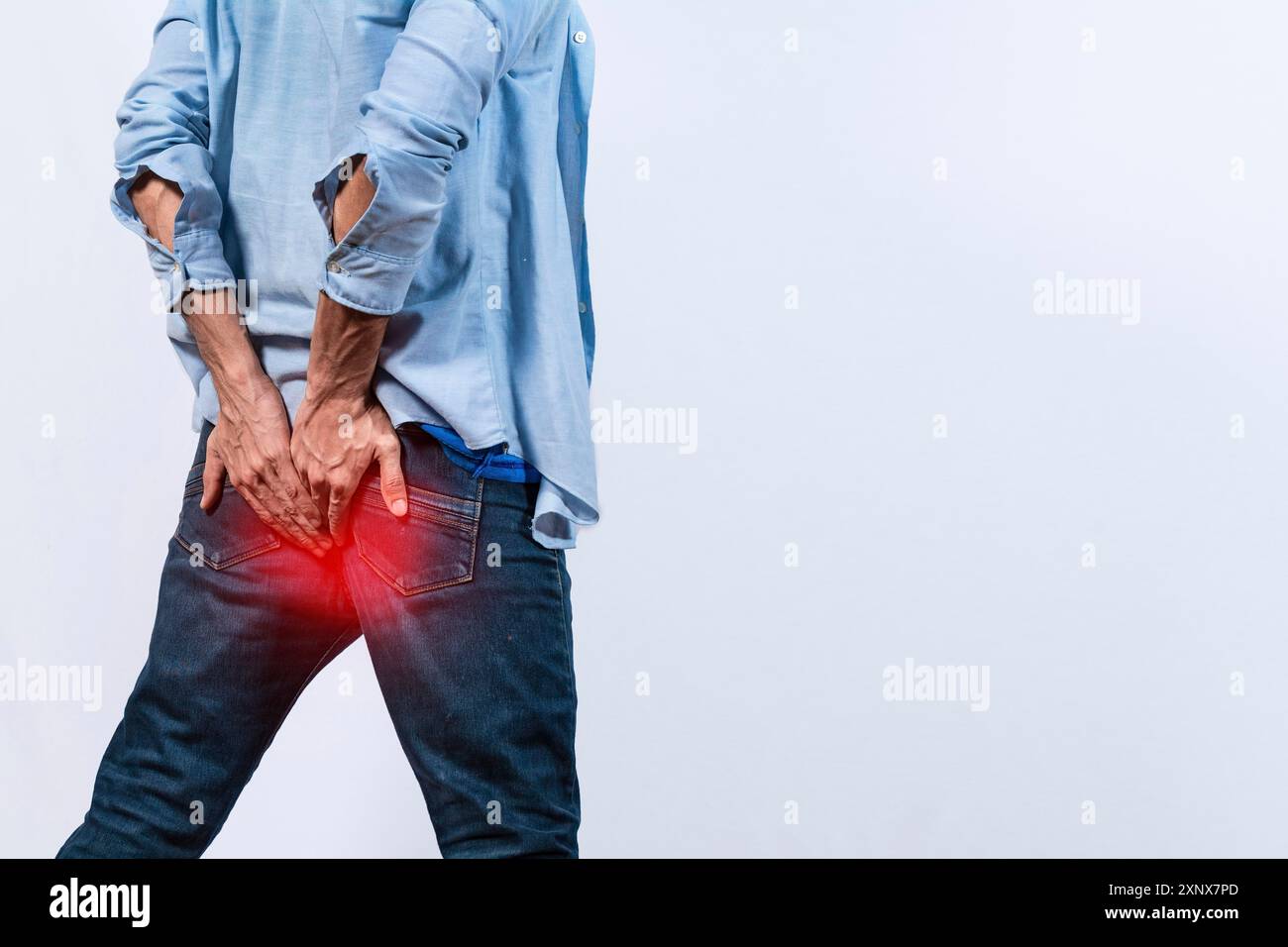 Man with digestive problem touching his buttock, man with hemorrhoid ...