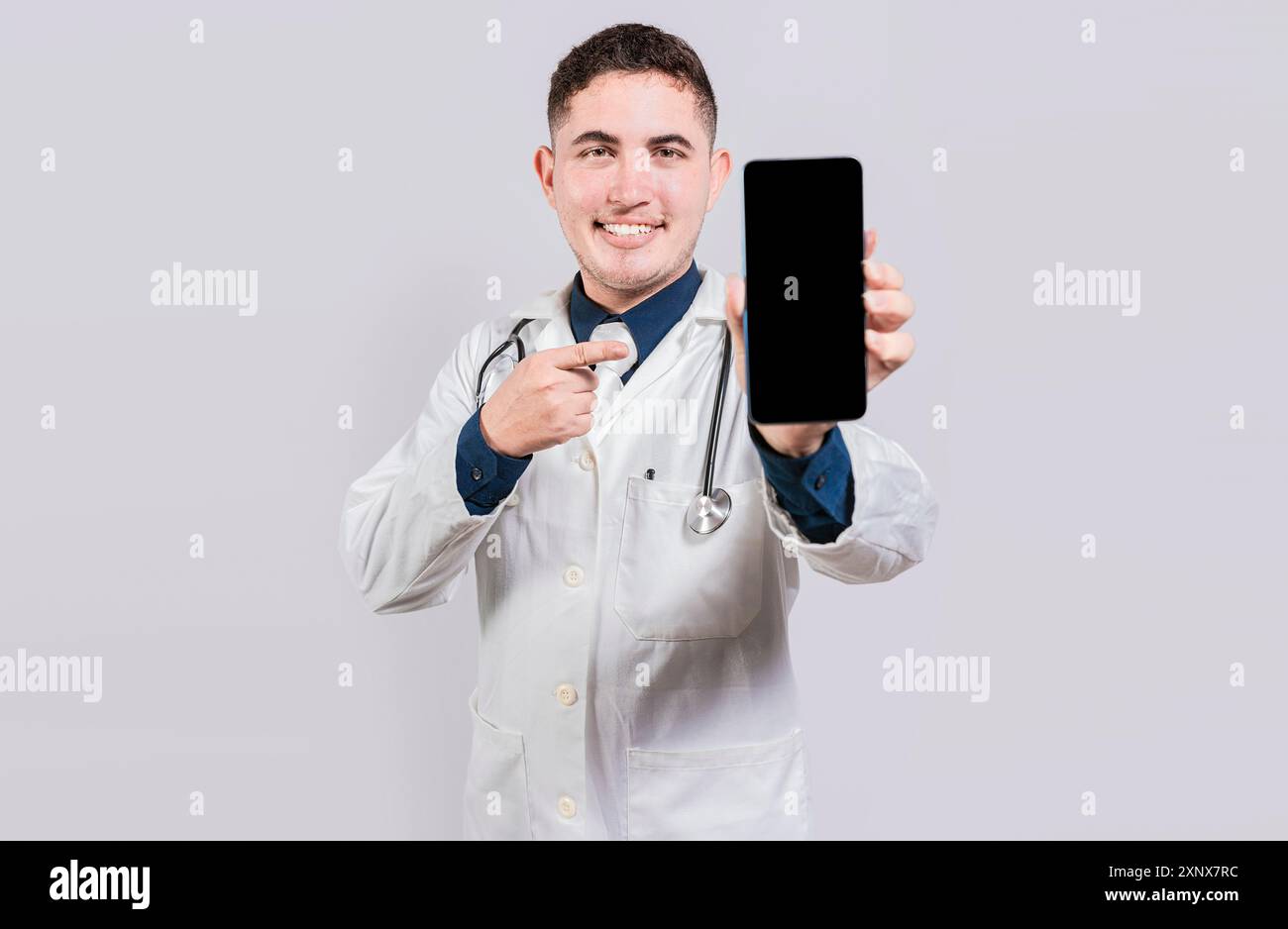 Smiling doctor showing an app on cell phone screen. Happy young doctor ...