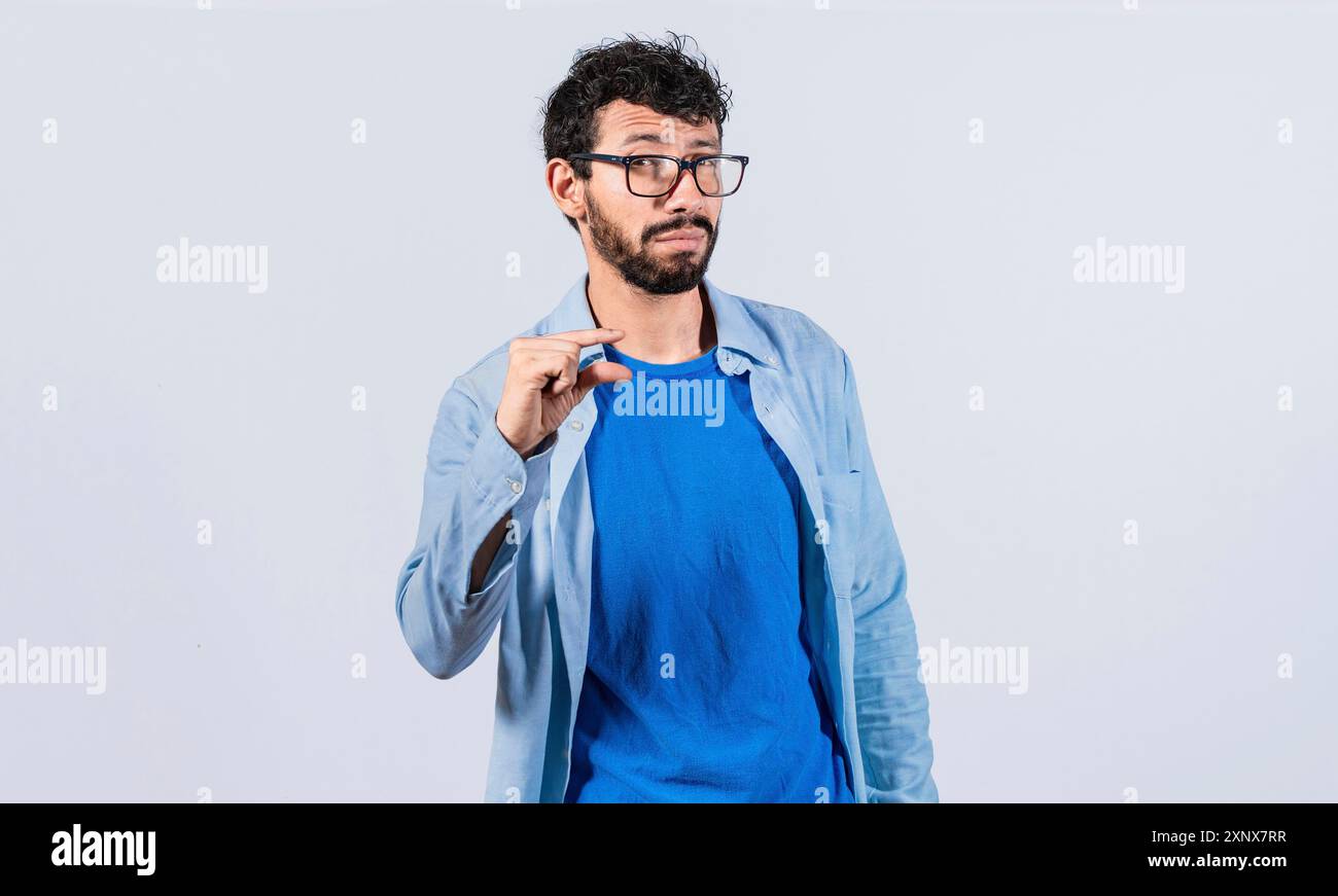 Man showing a small amount with fingers isolated. Young man gesturing ...