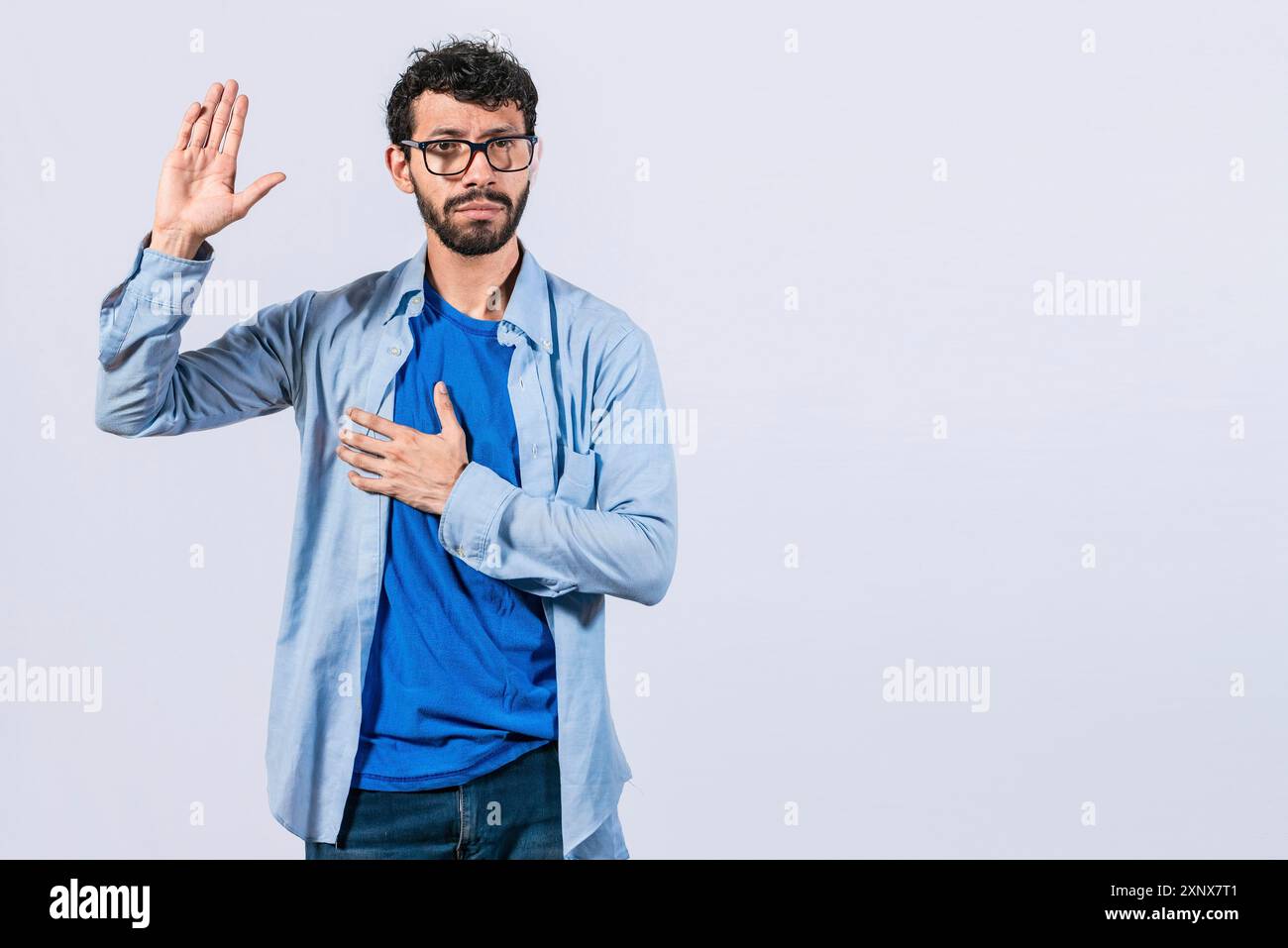 Man swearing honesty and devotion isolated. Honest man raising hand ...