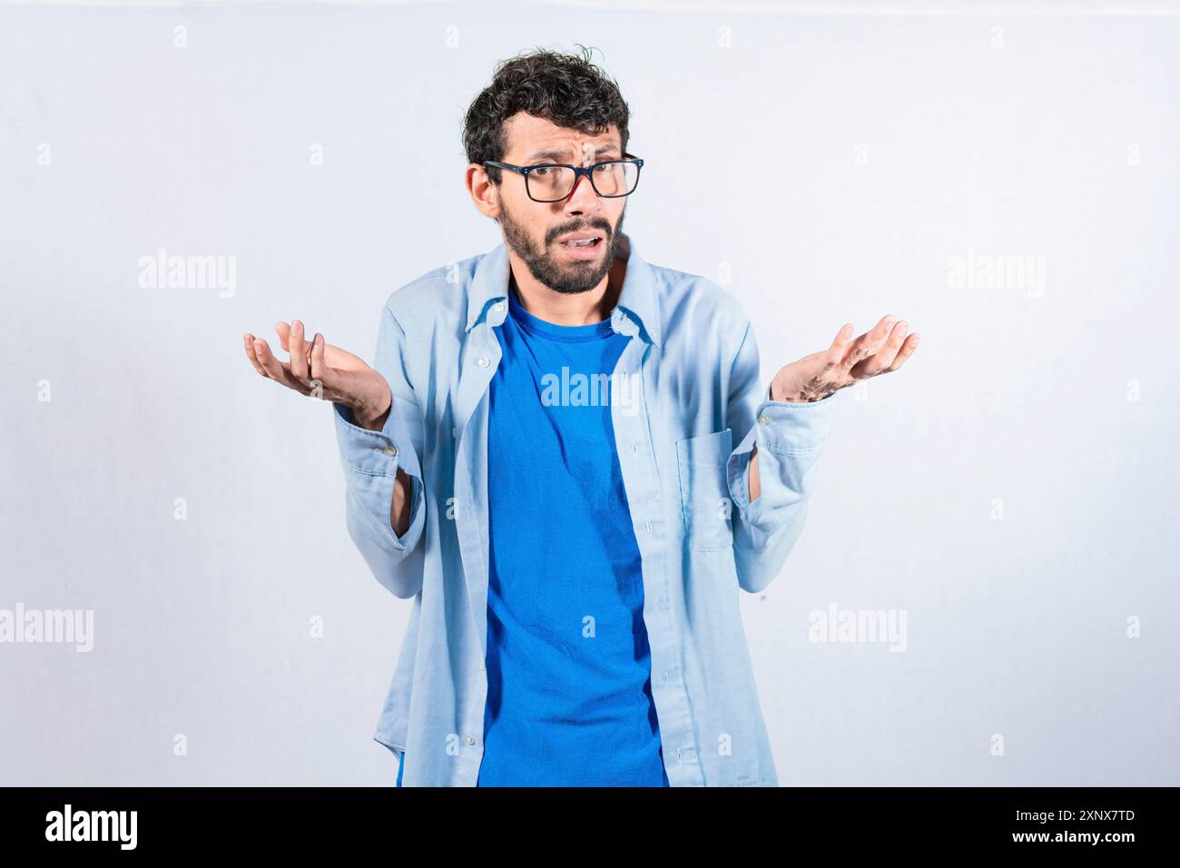 Man spreading palms, feeling clueless and uncertain isolated. Young man ...