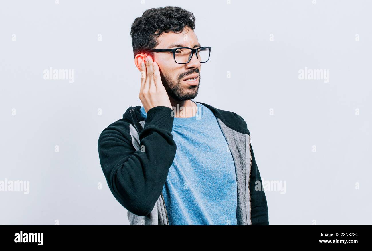 Person with ear pain, on isolated background, Suffering man massaging ...