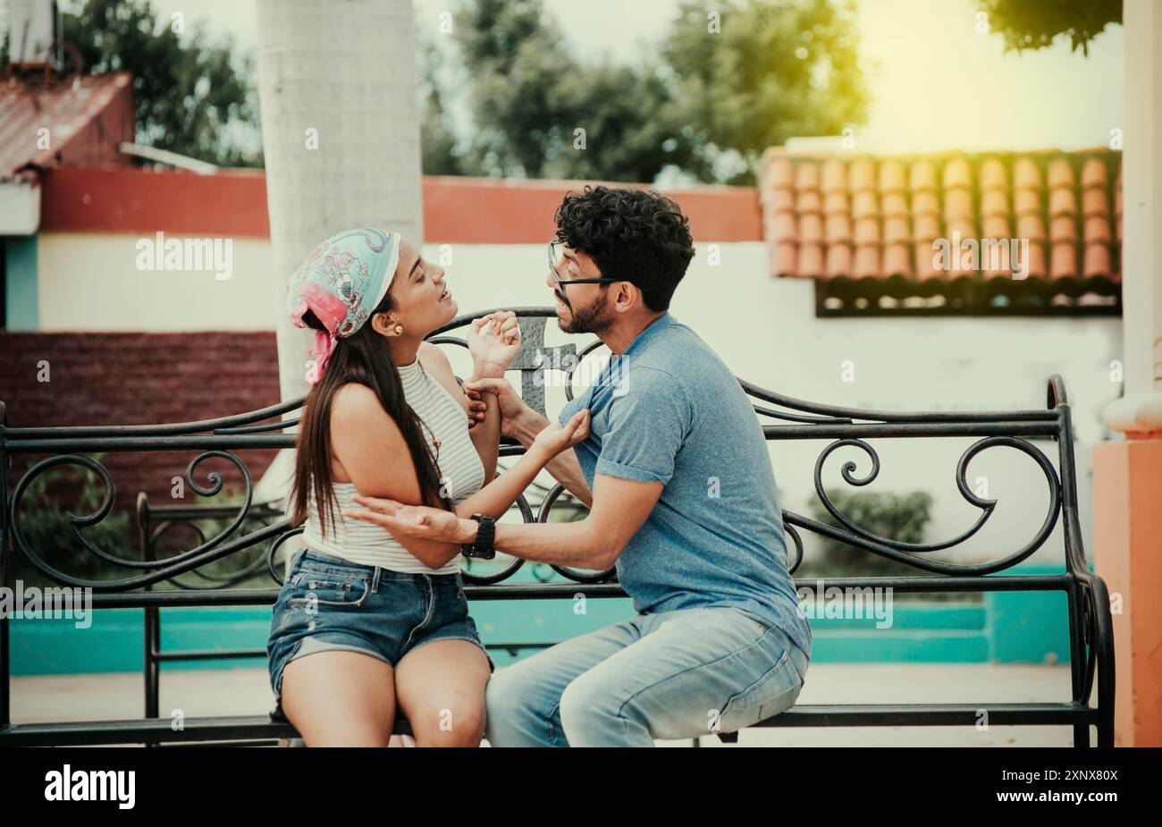 Man arguing with girlfriend sitting in a park. Young couple arguing ...