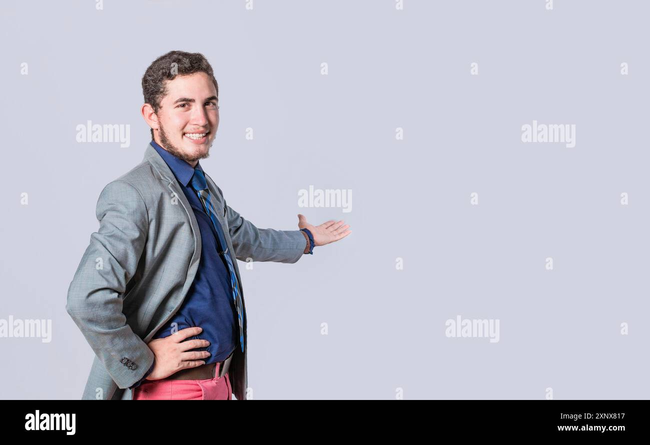Man pointing back and presenting a product, man in a suit welcoming ...