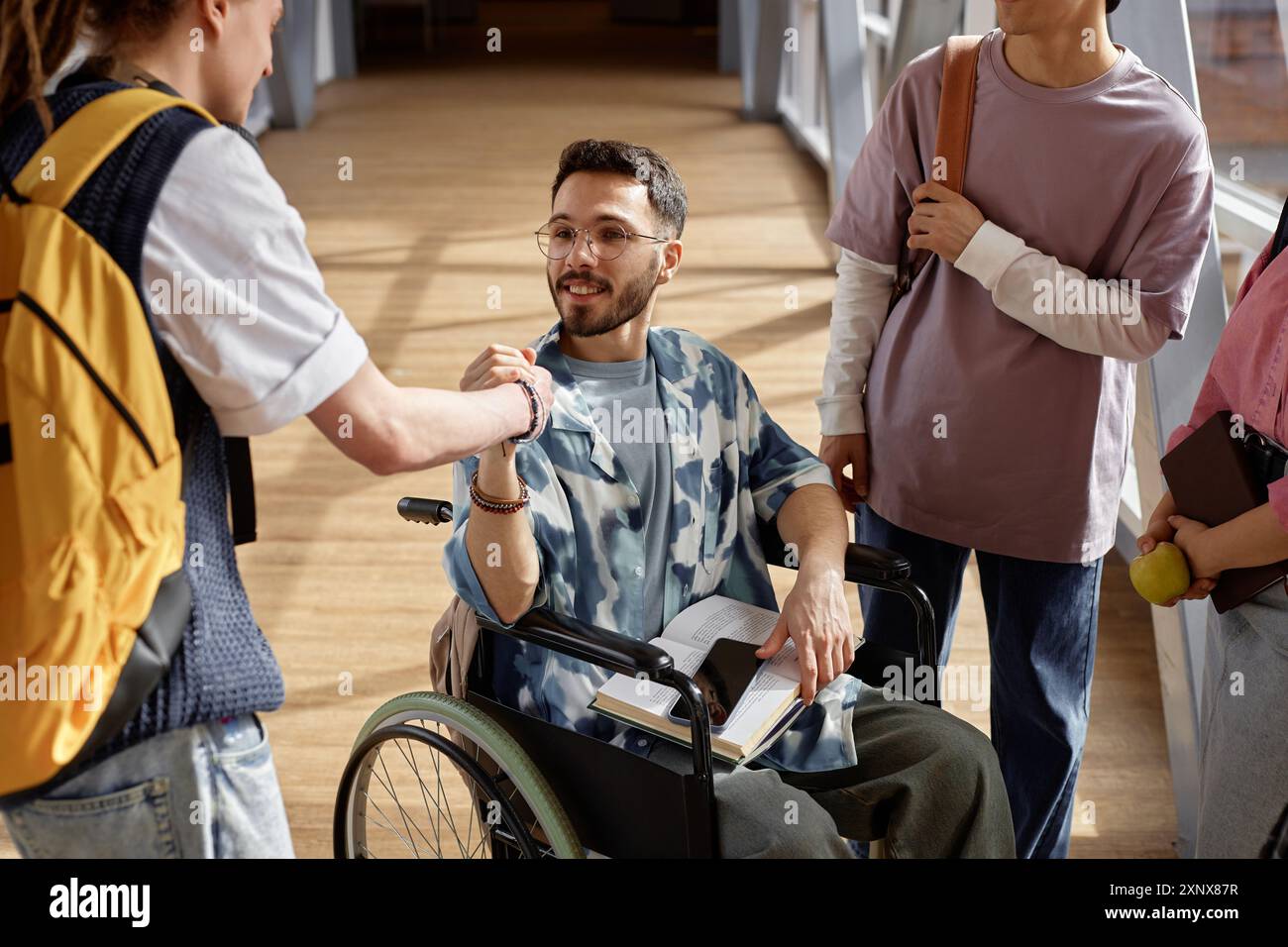 Portrait shot of happy Middle Eastern male student using wheelchair ...