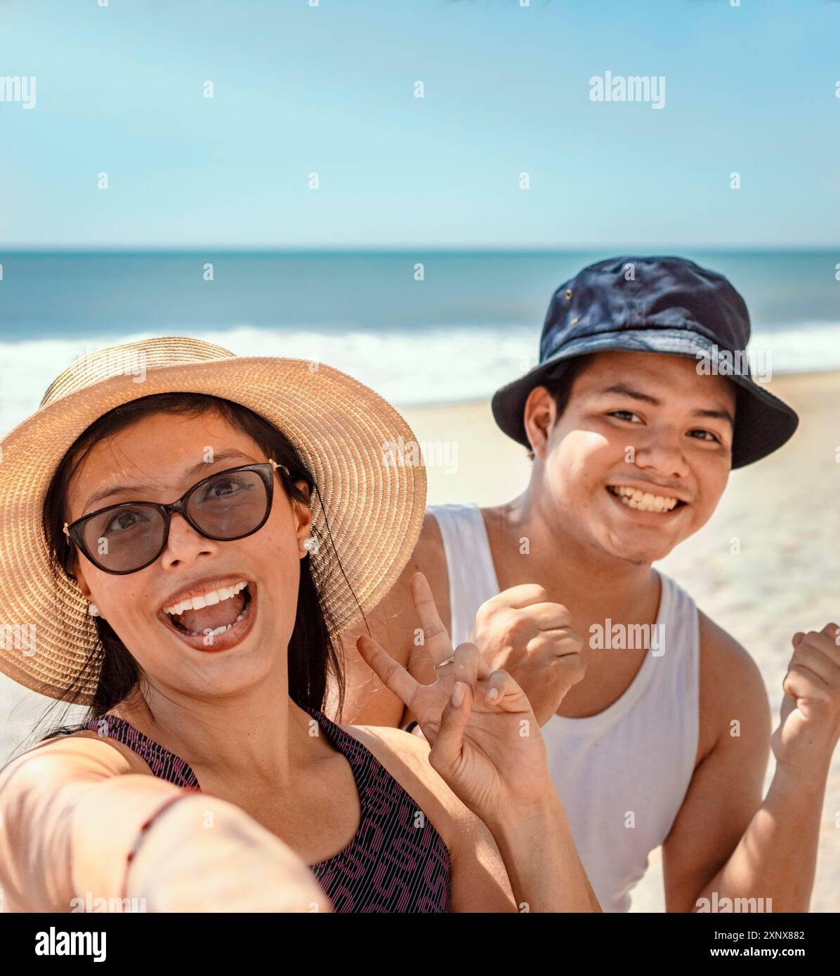 Two happy friends taking a selfie on the beach. Selfie of two happy ...