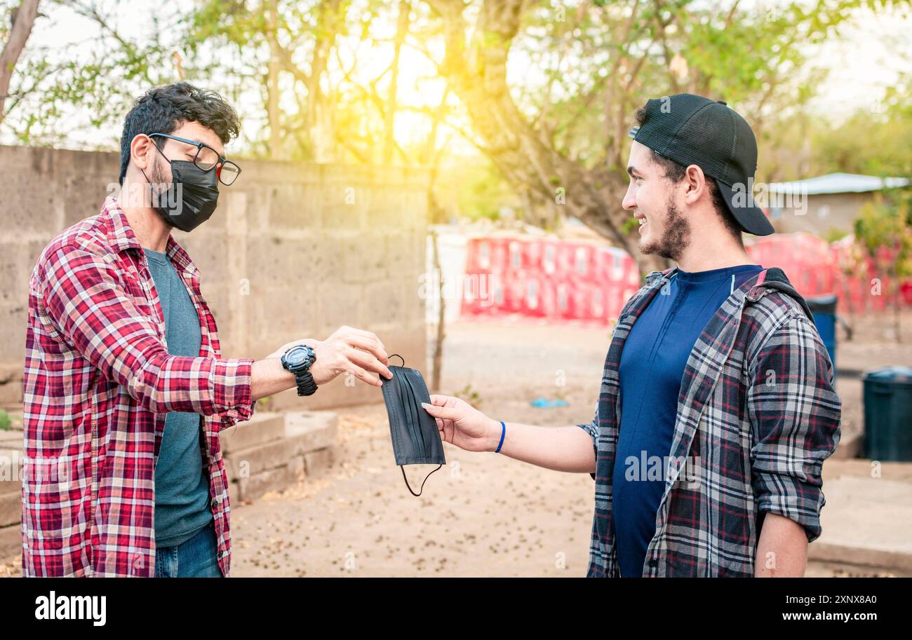 Concept of a person giving a surgical mask, Two young people giving ...