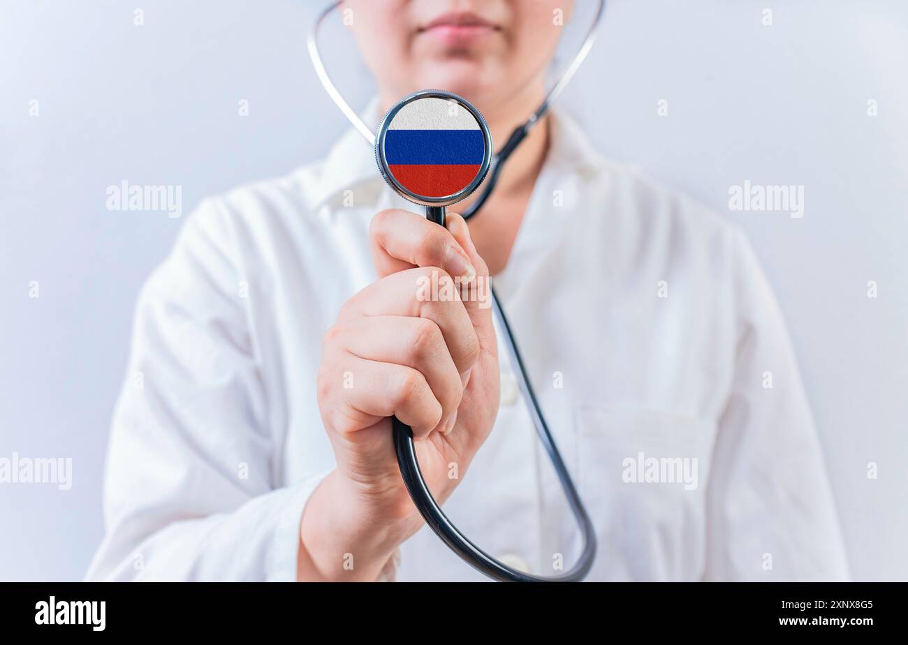 Female doctor holding stethoscope with with Russia flag. Russia health ...
