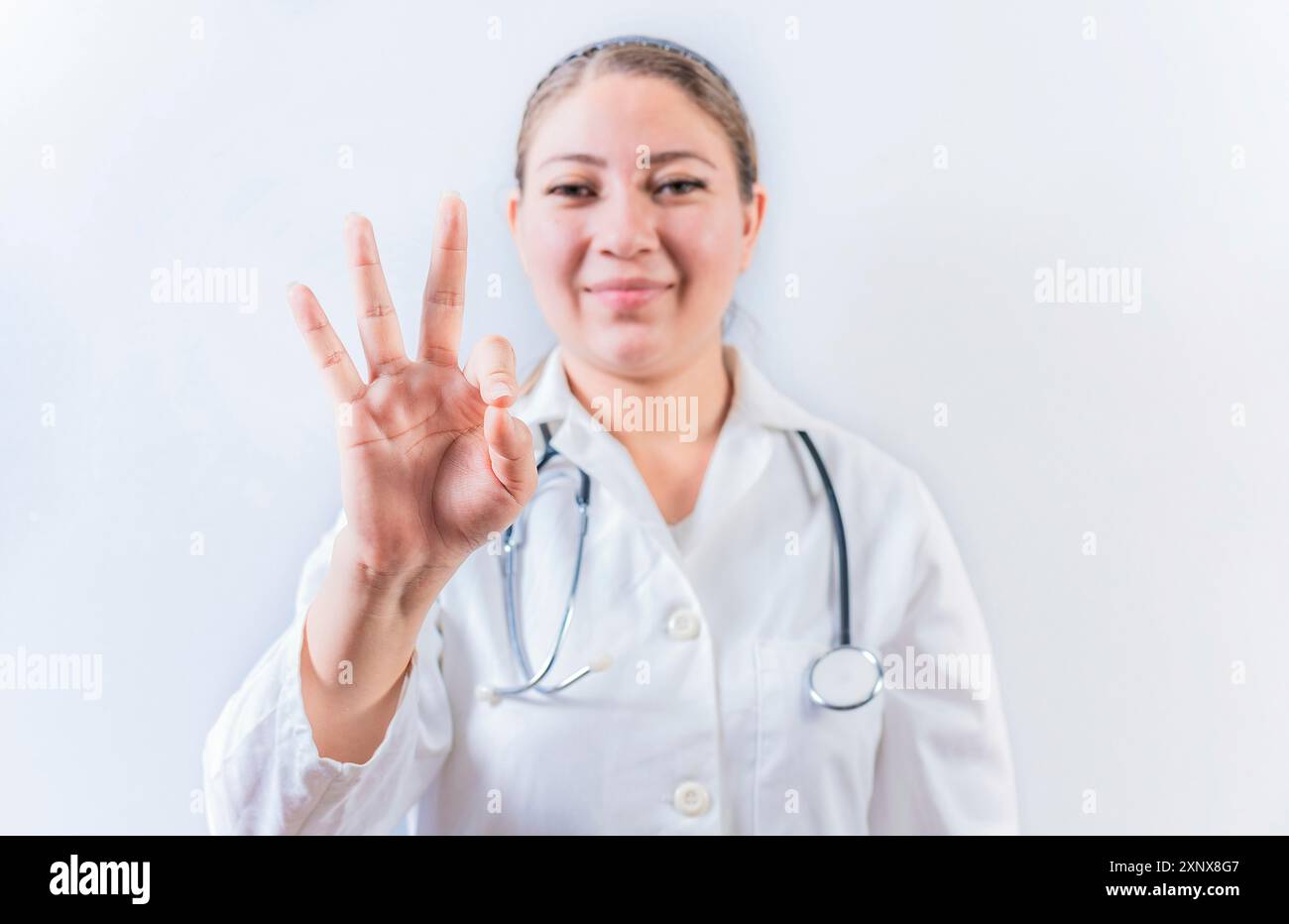Female doctor counting number THREE isolated. Young female doctor ...