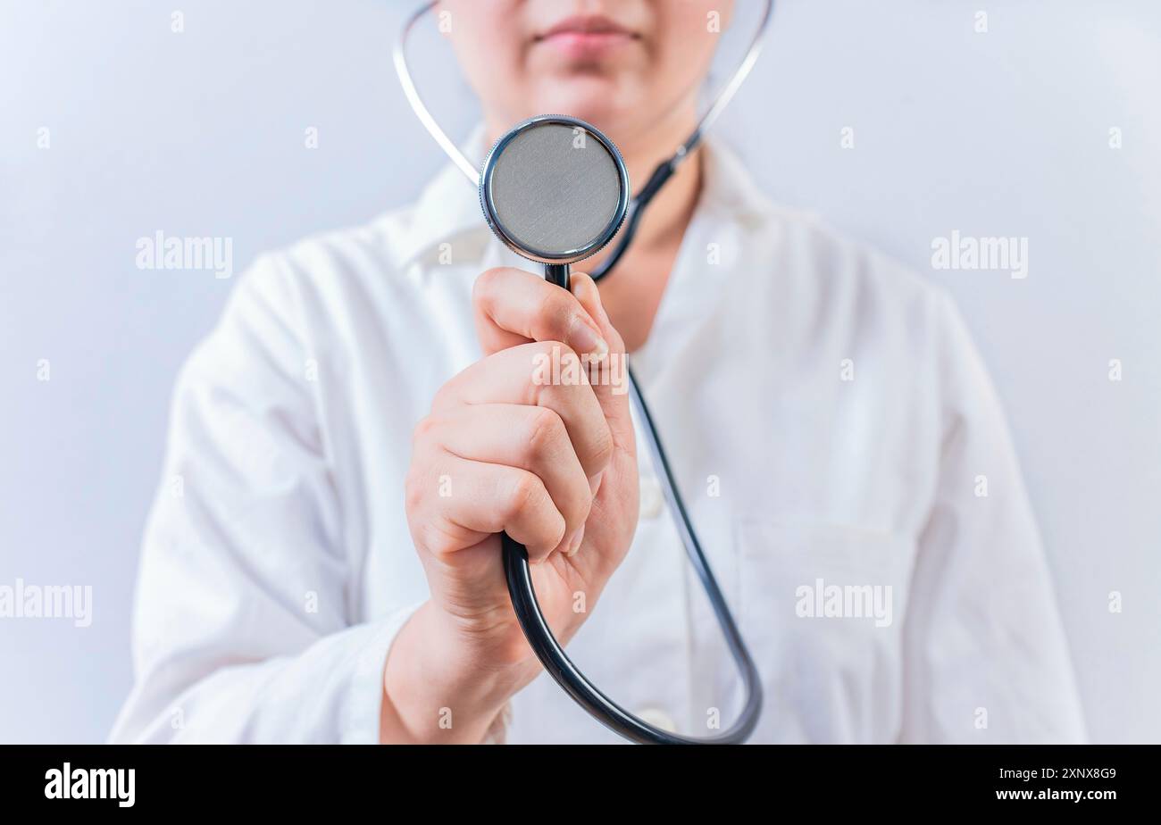 Female doctor hand showing stethoscope isolated. Female doctor holding ...