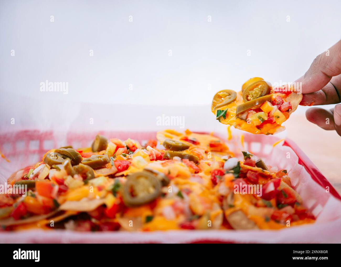 Hand of people taking nachos on isolated background. Hand taking nachos ...