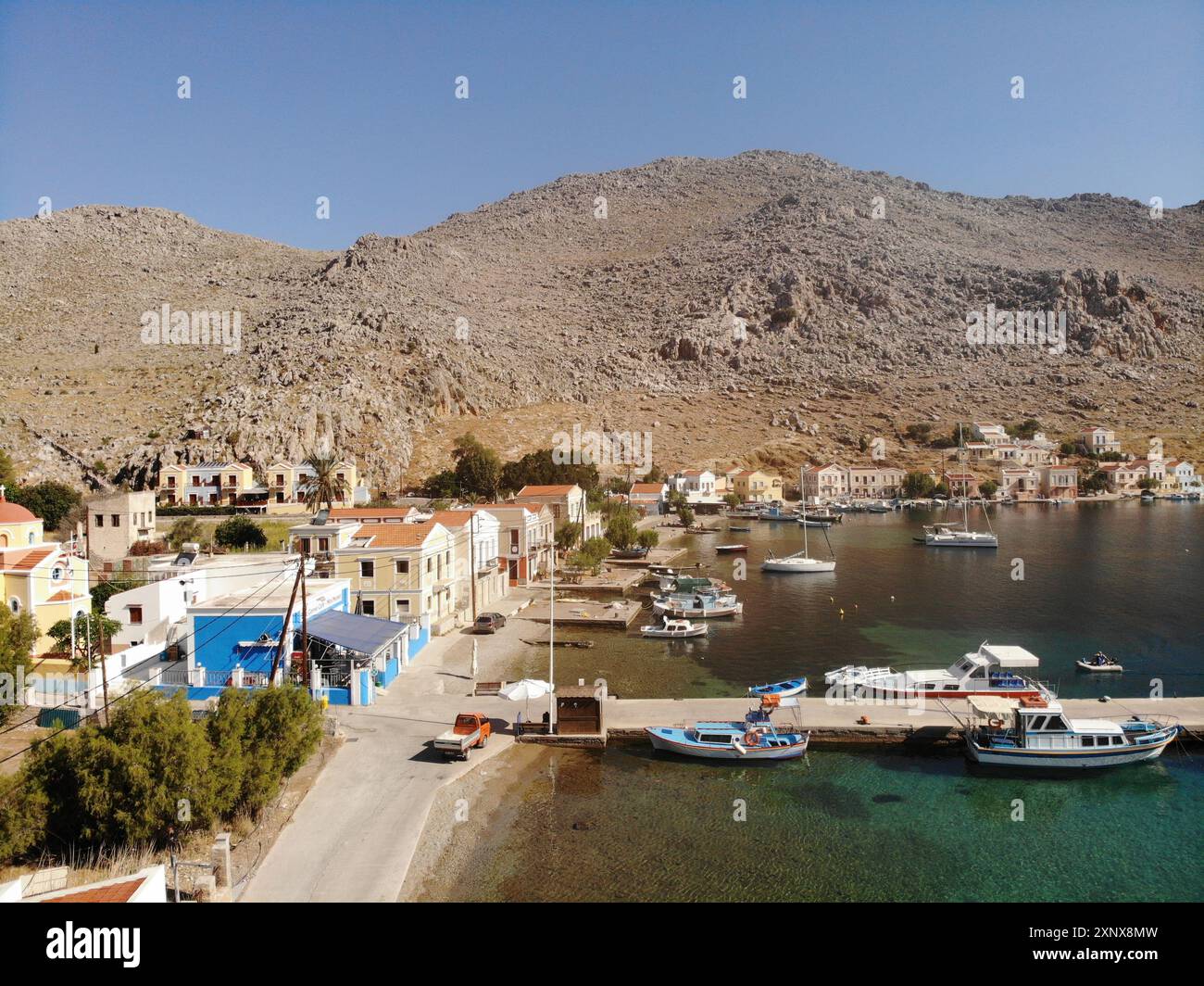 Aerial birds eye view of Pedi Bay shoreline and hills at Symi Island ...