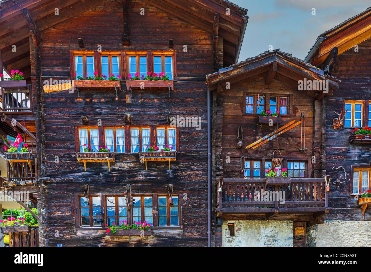Old wooden houses with flower boxes in front of windows and balconies ...