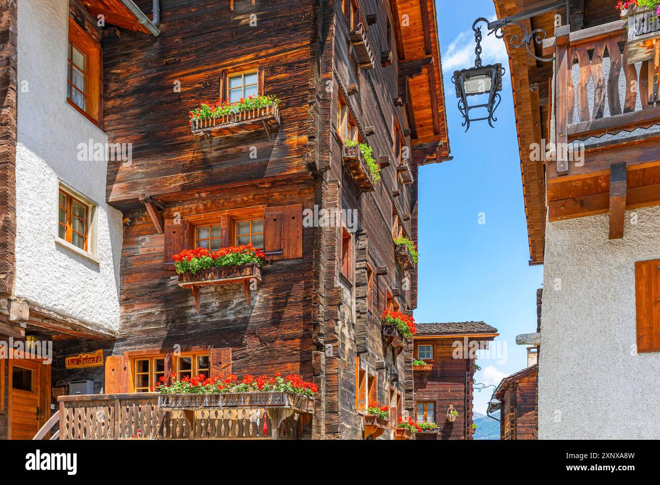 Old houses with flower boxes in front of windows and balconies in the ...