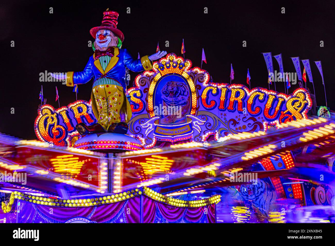 Illuminated round and elevated ride Circus Circus gondolas in motion ...