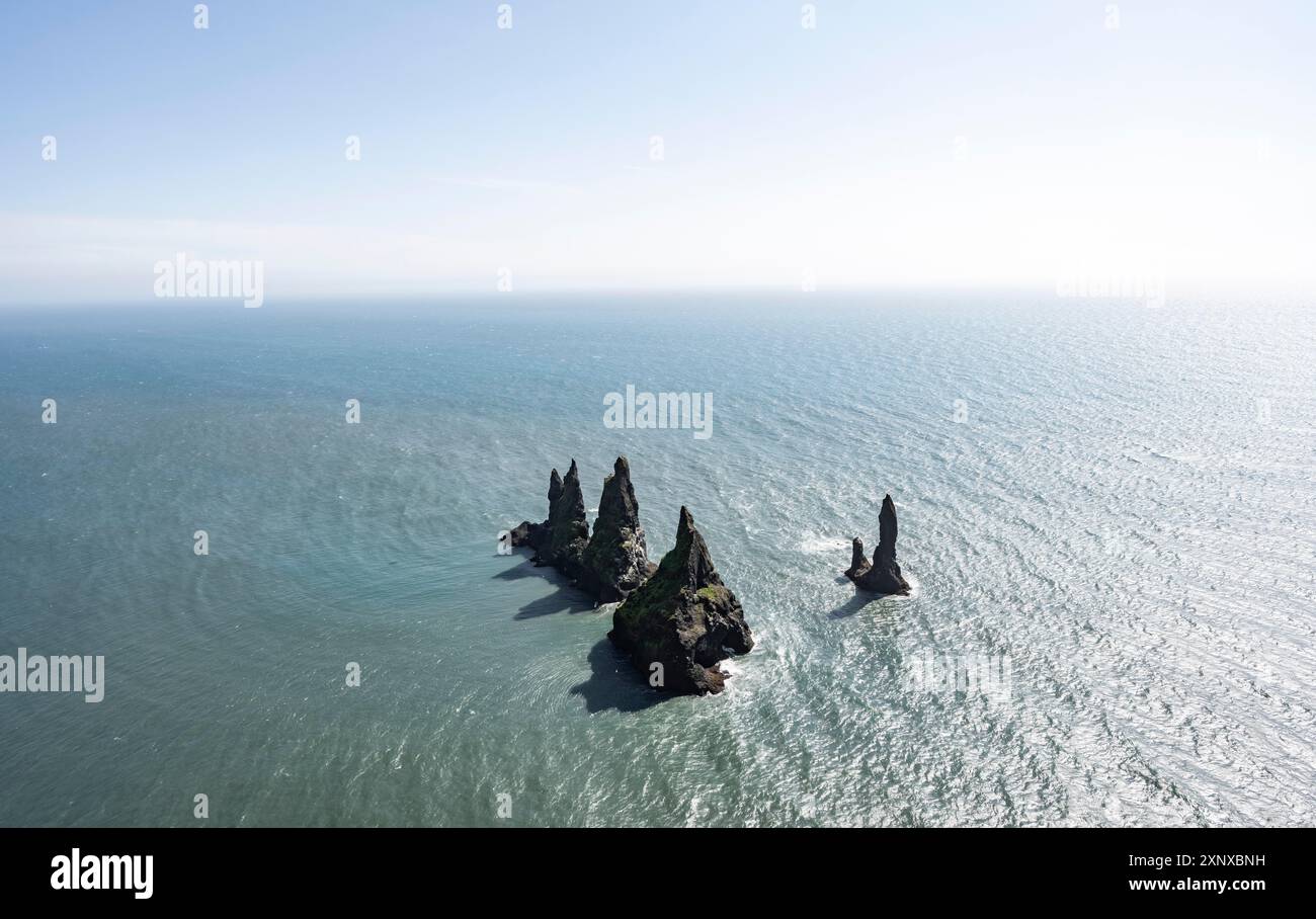 Steep coast, view from steep cliff to the rocks Reynisdrangar in the ...