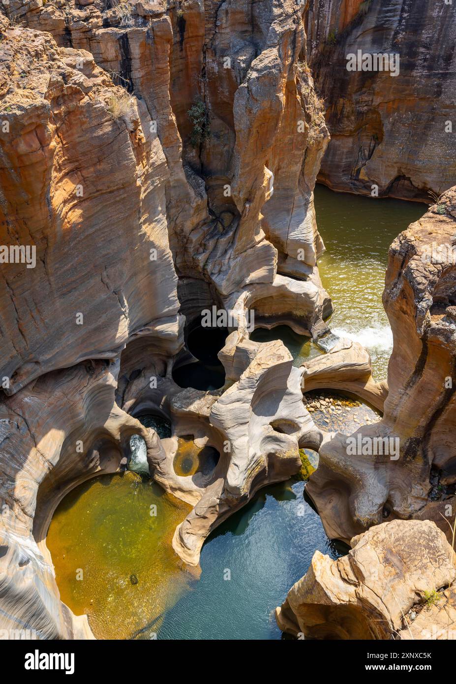 Eroded rock formations, canyon with steep orange-coloured rock cliffs ...