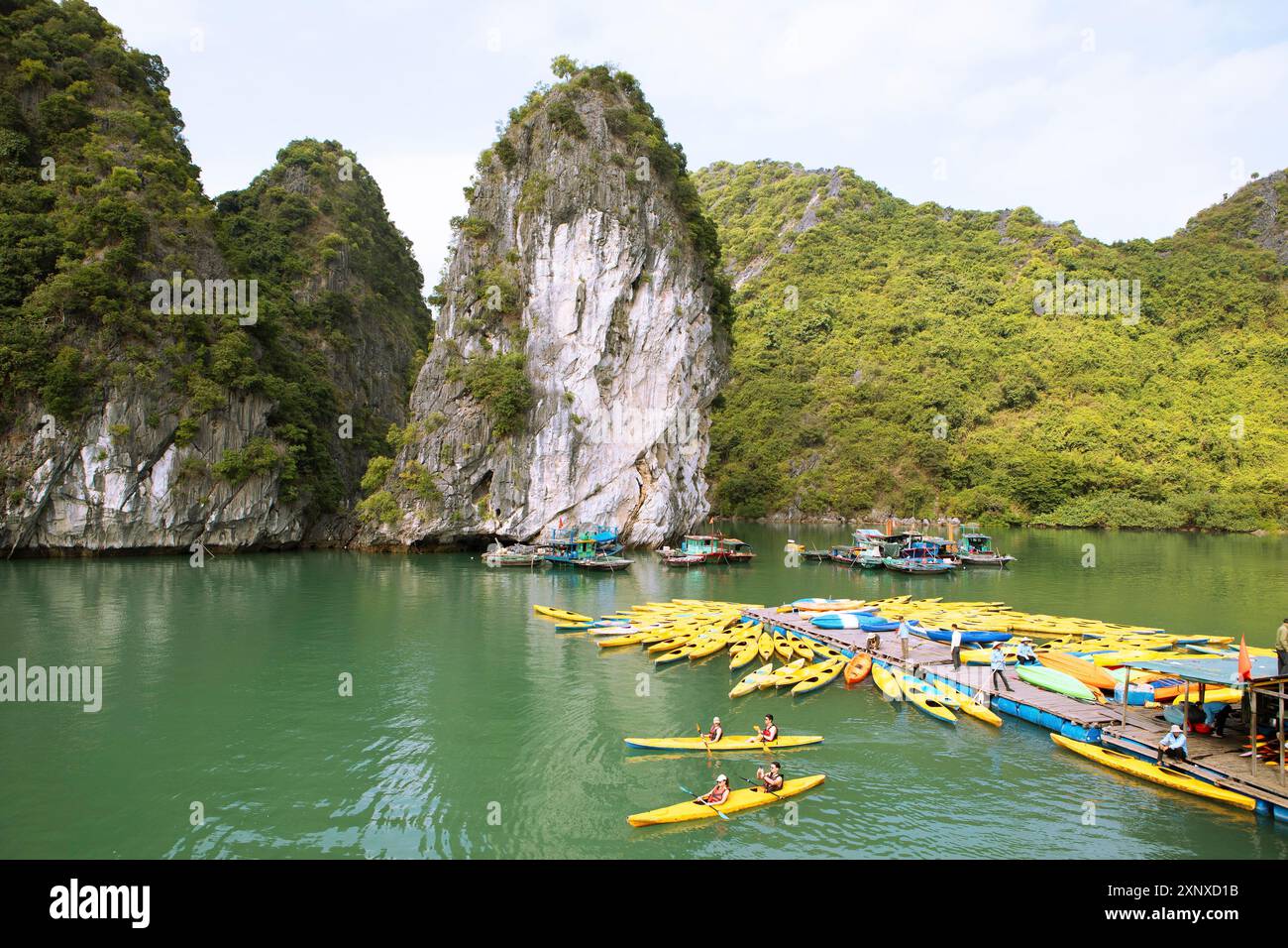 Yellow kayaks at a jetty and the karst rocks in Lan Ha Bay, Halong Bay ...