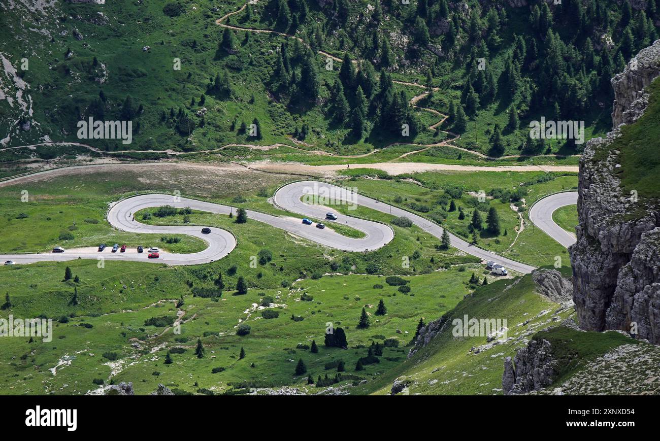 winding mountain road with sharp hairpin turns ascending the mountain ...