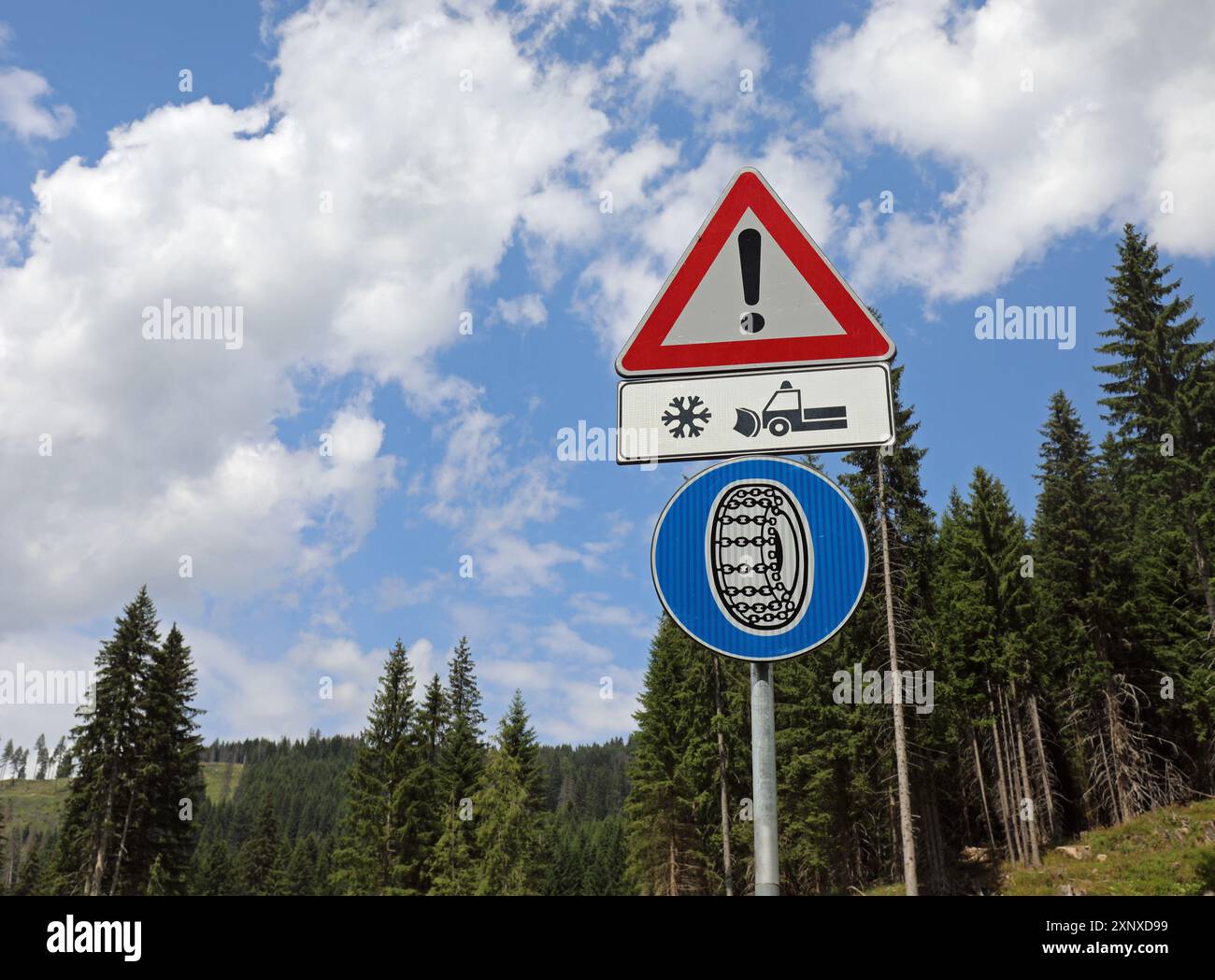 Road sign indicating the mandatory use of snow chains and snowplow ...